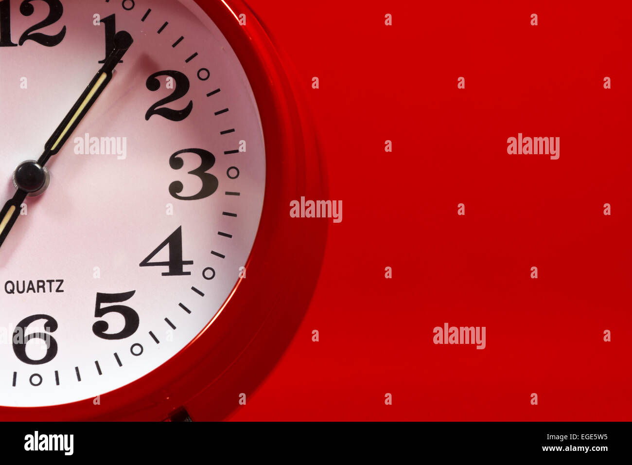 Red alarm clock on a red background with copy space Stock Photo - Alamy