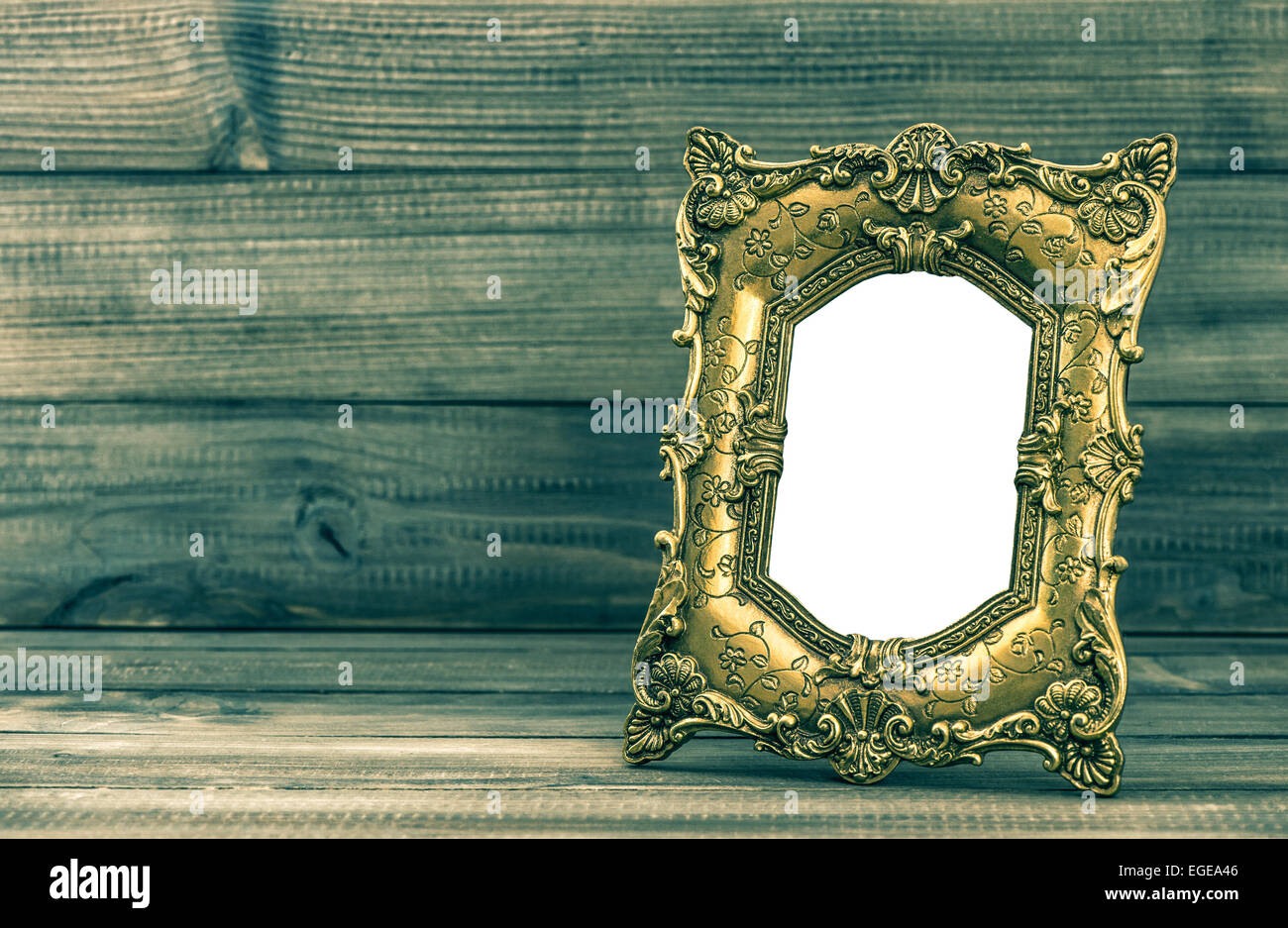 Golden baroque style frame on wooden background with place for your ...