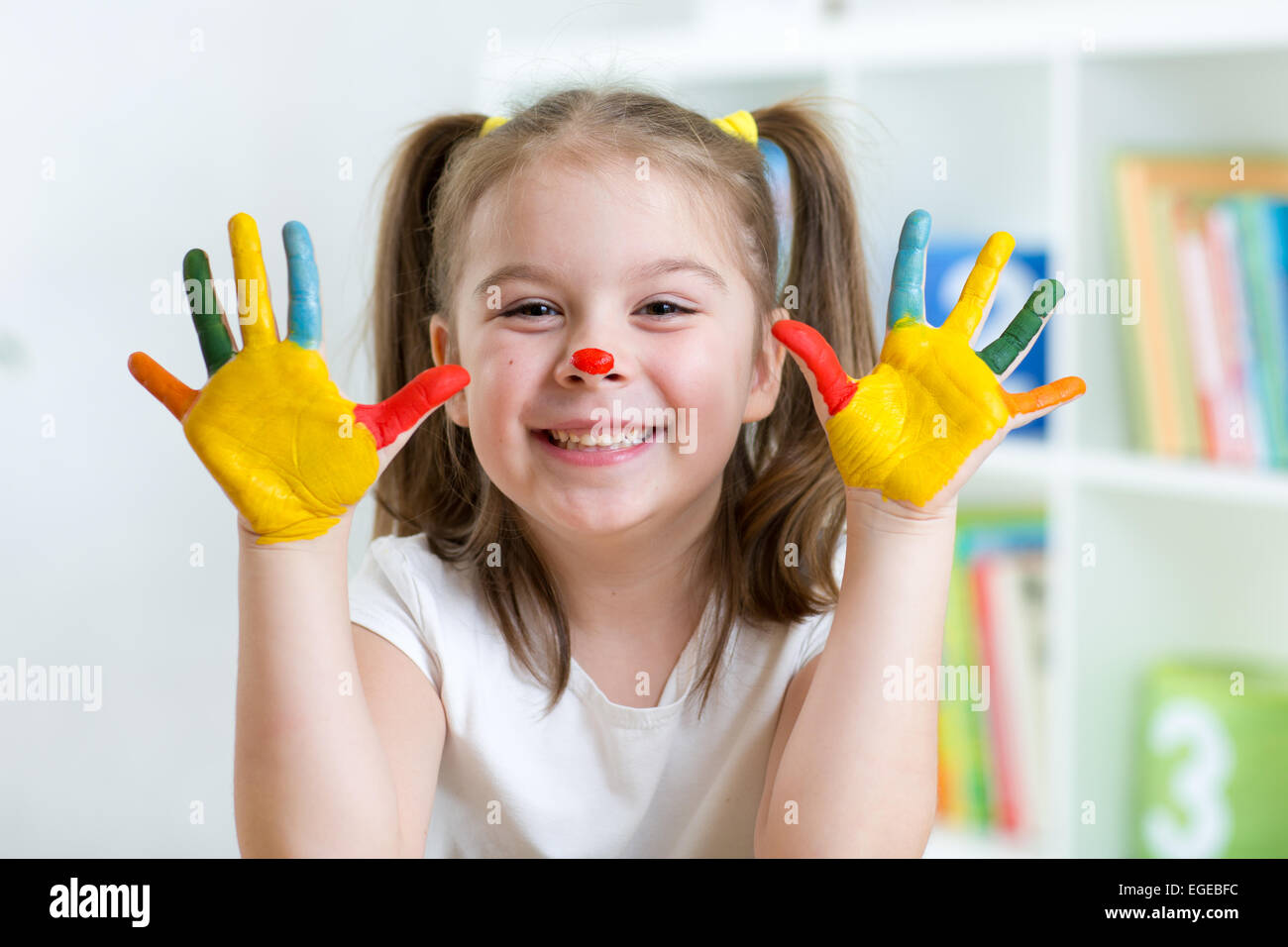cute cheerful child with painted hands and face Stock Photo - Alamy
