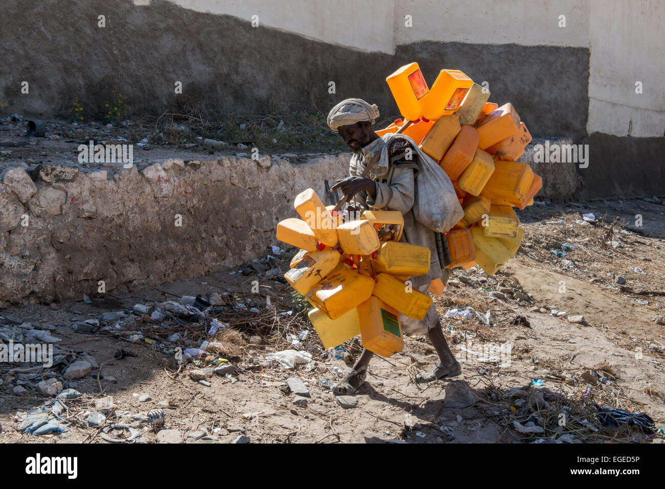 Man Carrying Yellow Containers At The Monday Market, Keren Stock Photo ...