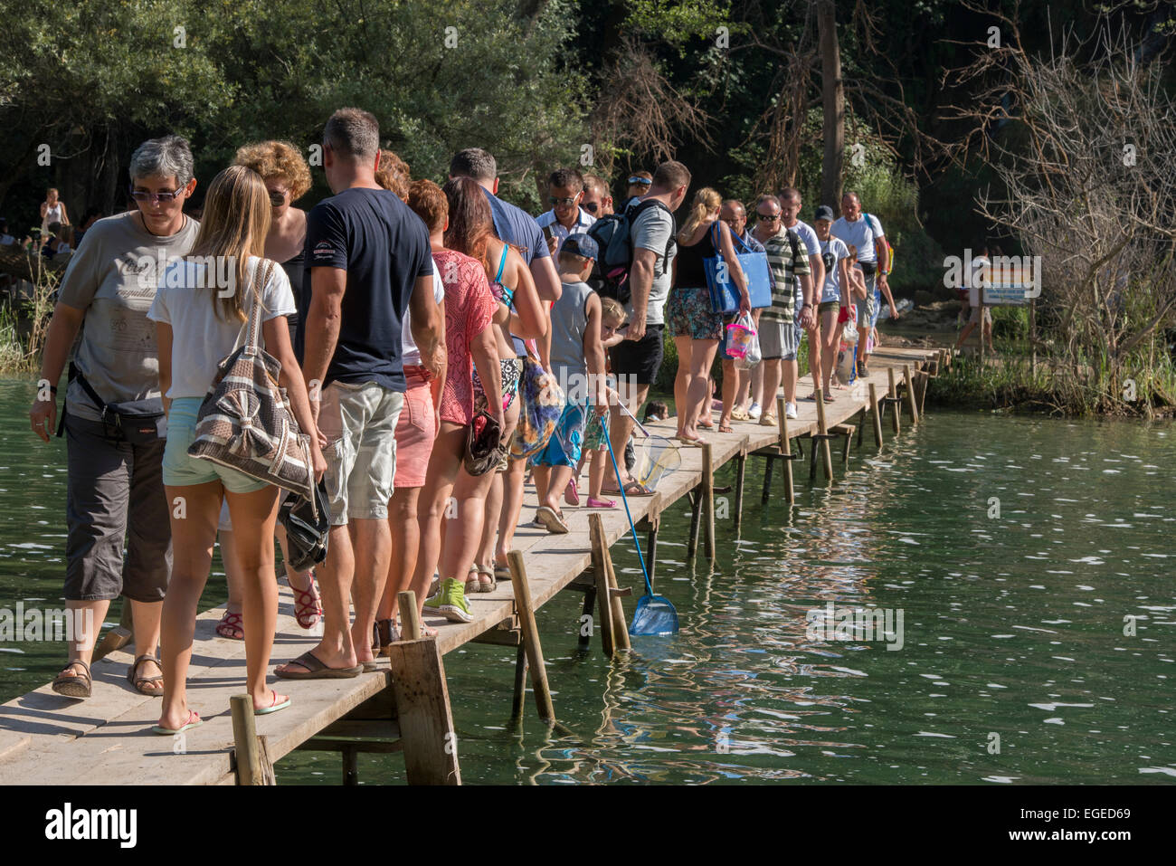 People Crossing On A Stilt Bridge, Kravica Waterfall Stock Photo - Alamy