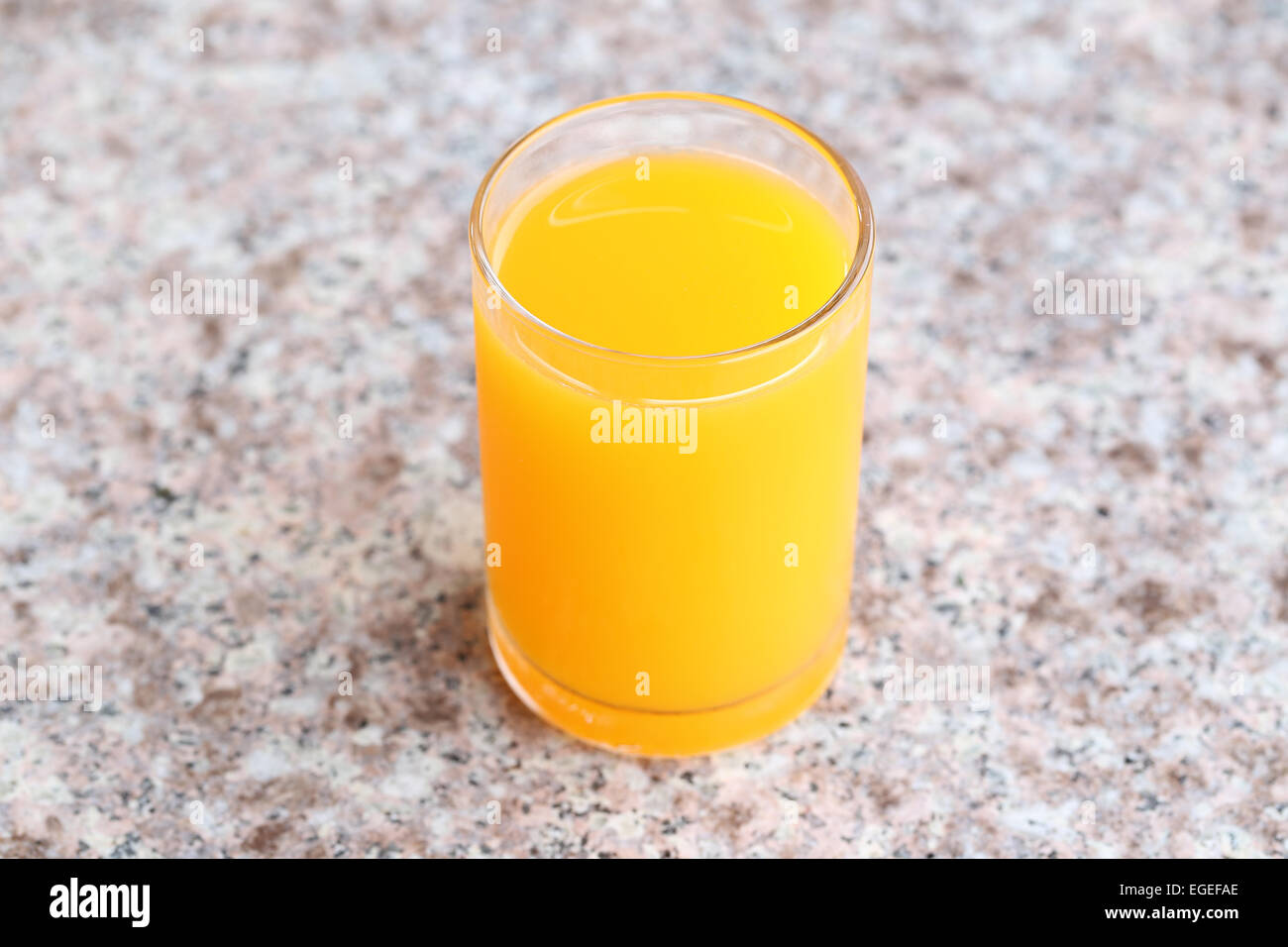 Glass of orange juice placed on a marble table Stock Photo - Alamy