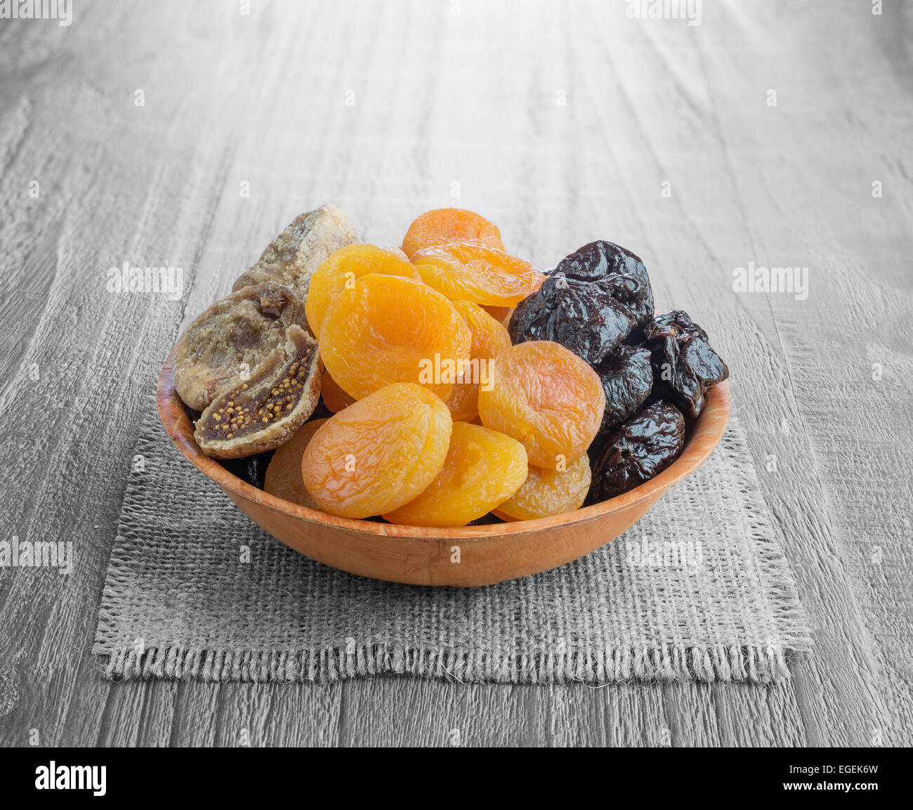 Dried pitted fruits on a wooden background Stock Photo - Alamy