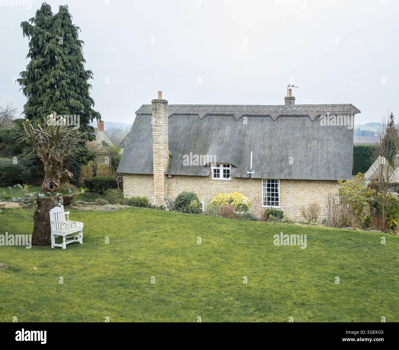 Thatched cottage and back garden of a country home in the village of ...