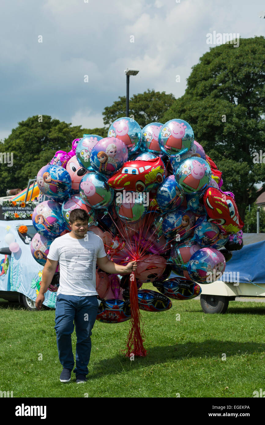 Man carrying large bunch of Balloons at open air carnival day in ...