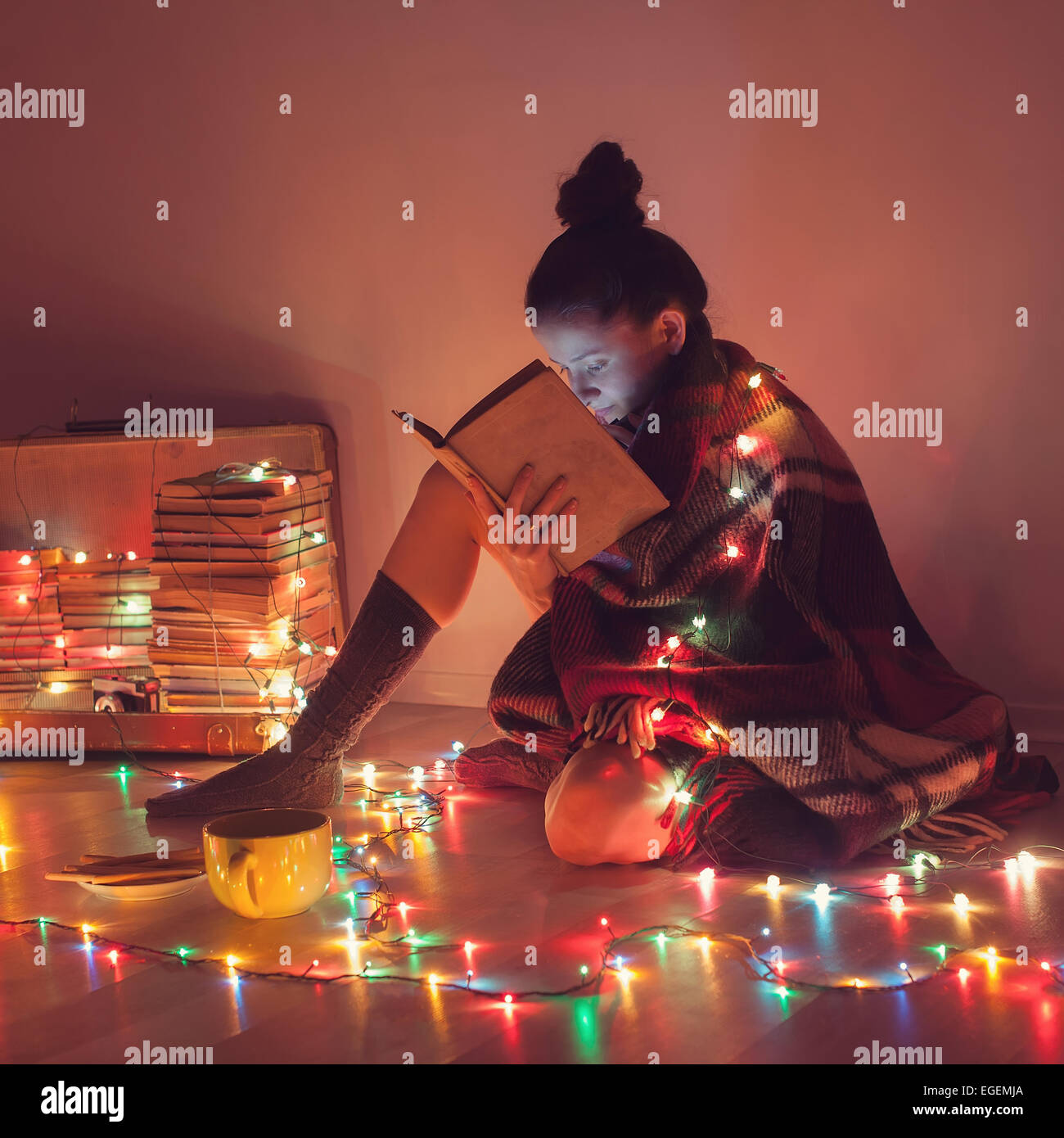 girl reading a book under blanket at home in cold weather Stock Photo ...