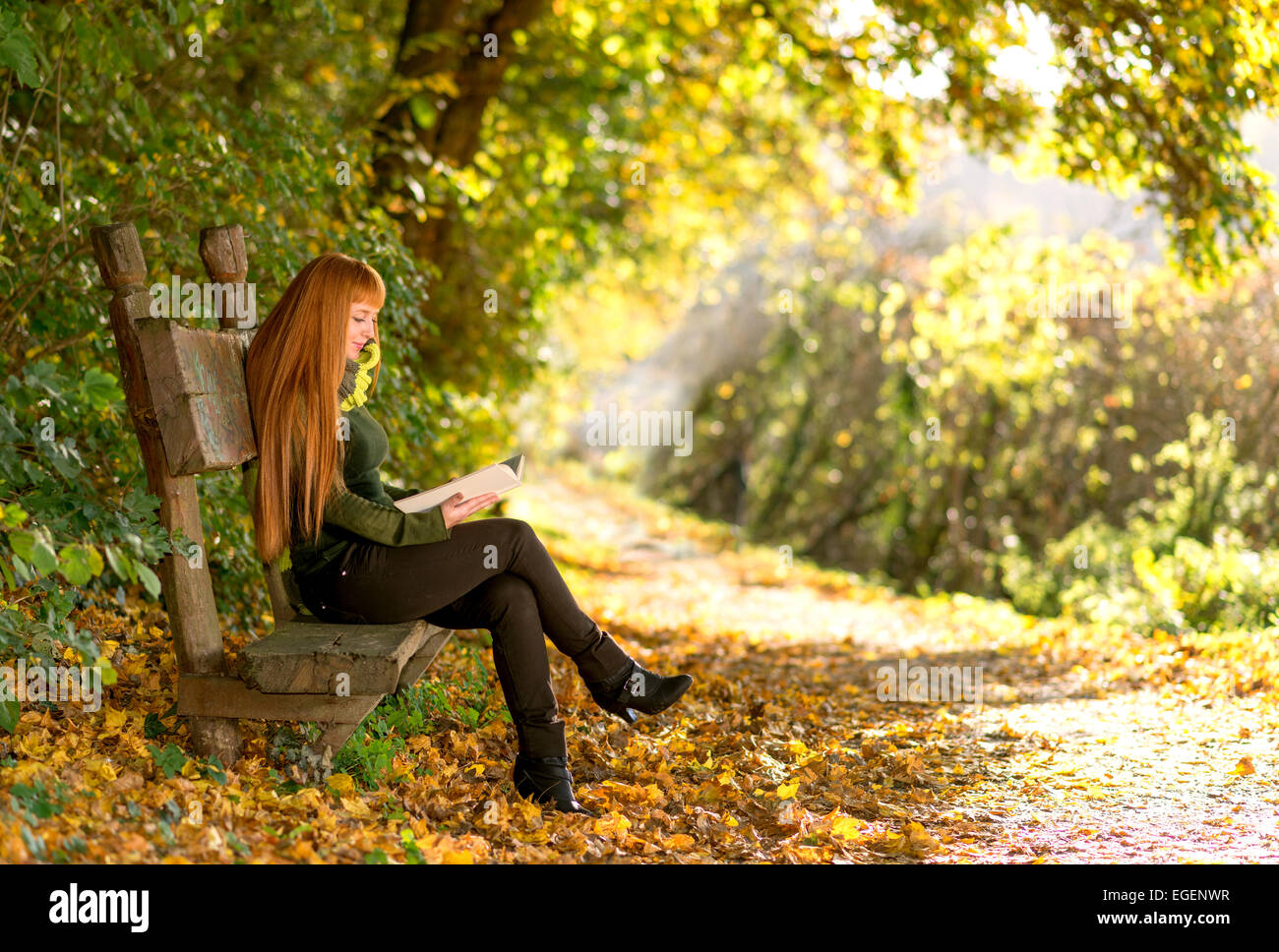 Woman reading in the autumn nature Stock Photo - Alamy
