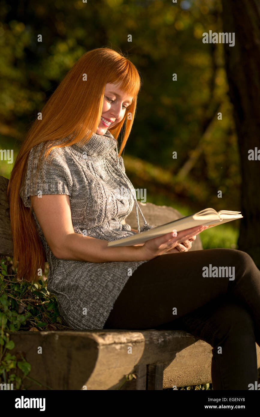 Woman read the book in autumn forest Stock Photo - Alamy