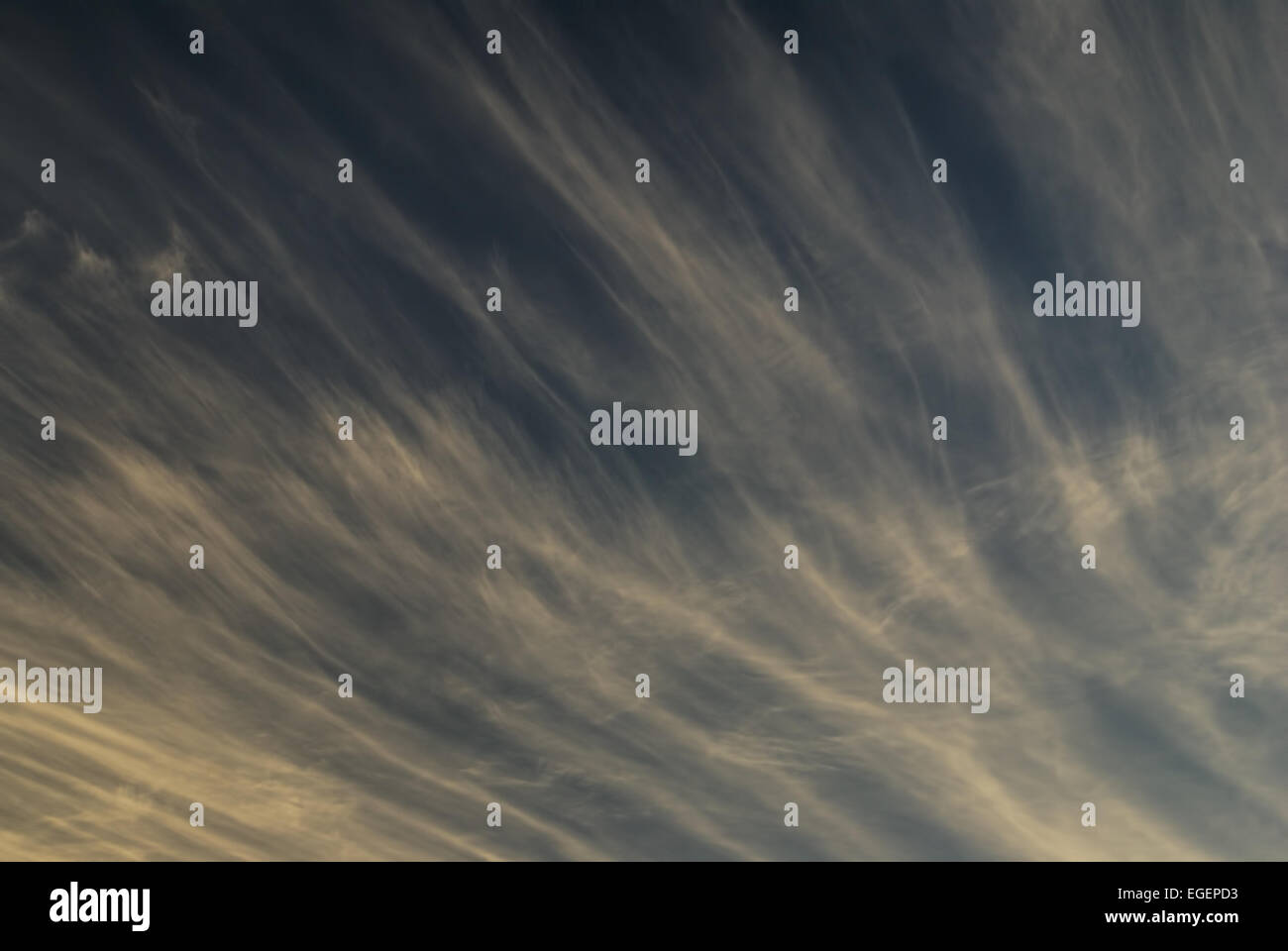 Close-up view of windswept sky slowly turning yellow Stock Photo - Alamy