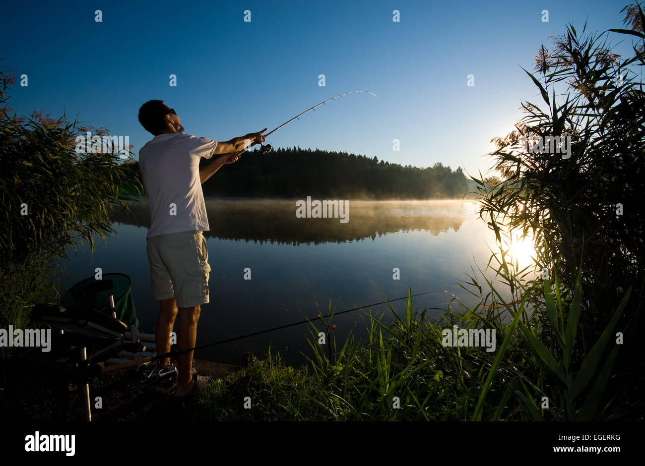 Fishing at sunrise Stock Photo - Alamy
