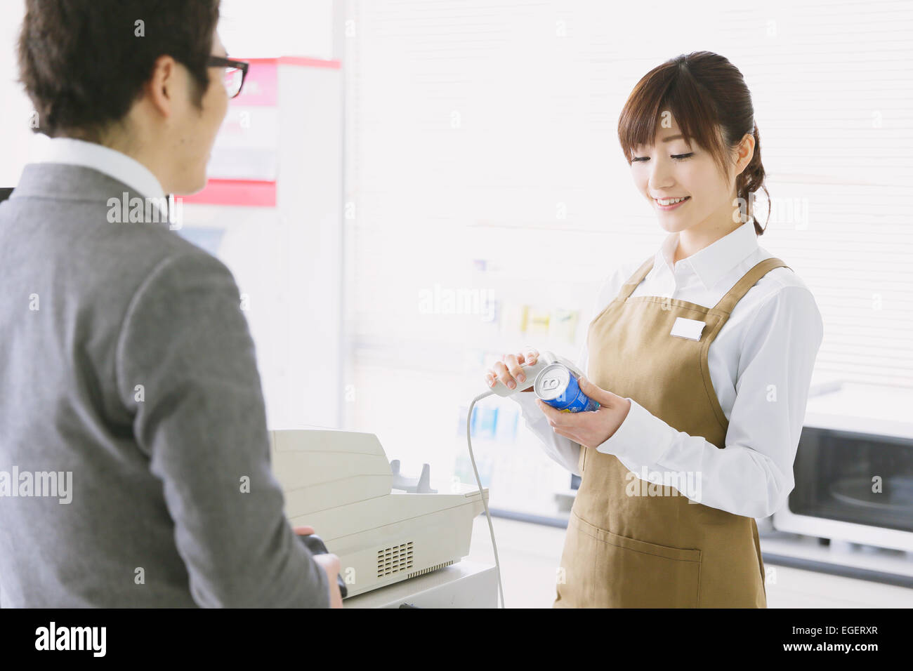 Young Japanese woman working at convenience store Stock Photo - Alamy