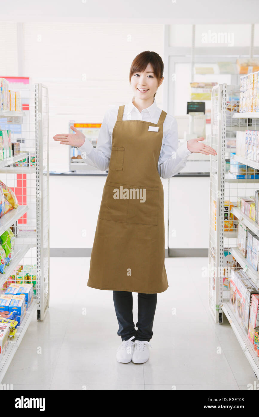 Young Japanese woman working at convenience store Stock Photo - Alamy