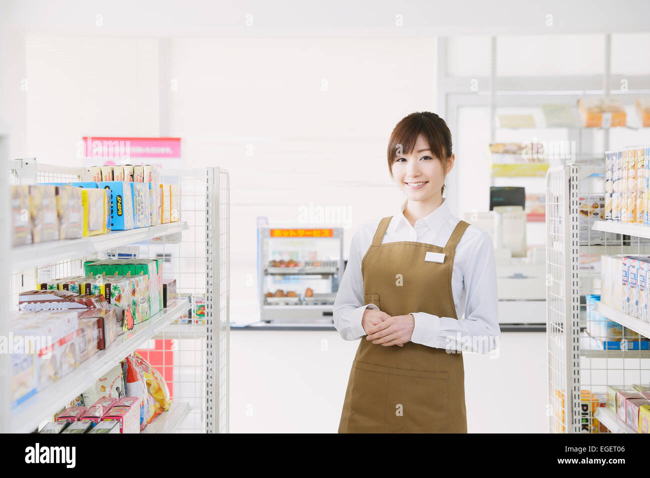 Young Japanese woman working at convenience store Stock Photo - Alamy