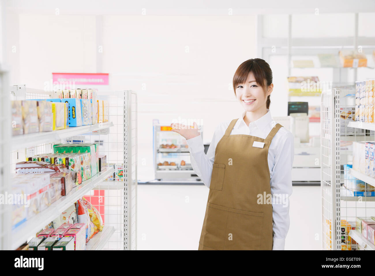 Young Japanese woman working at convenience store Stock Photo - Alamy