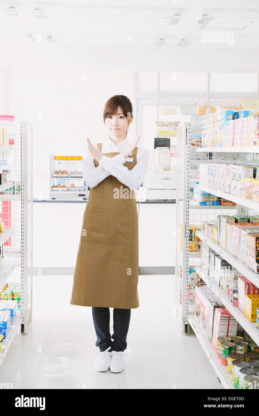 Young Japanese woman working at convenience store Stock Photo - Alamy