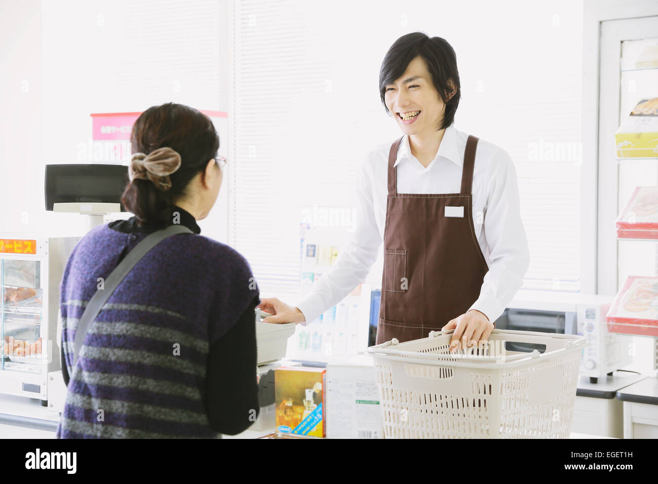 Young Japanese man working at convenience store Stock Photo - Alamy