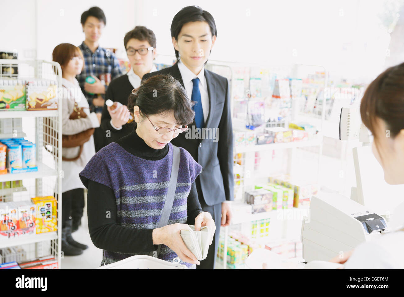 Customers shopping at a convenience store Stock Photo - Alamy