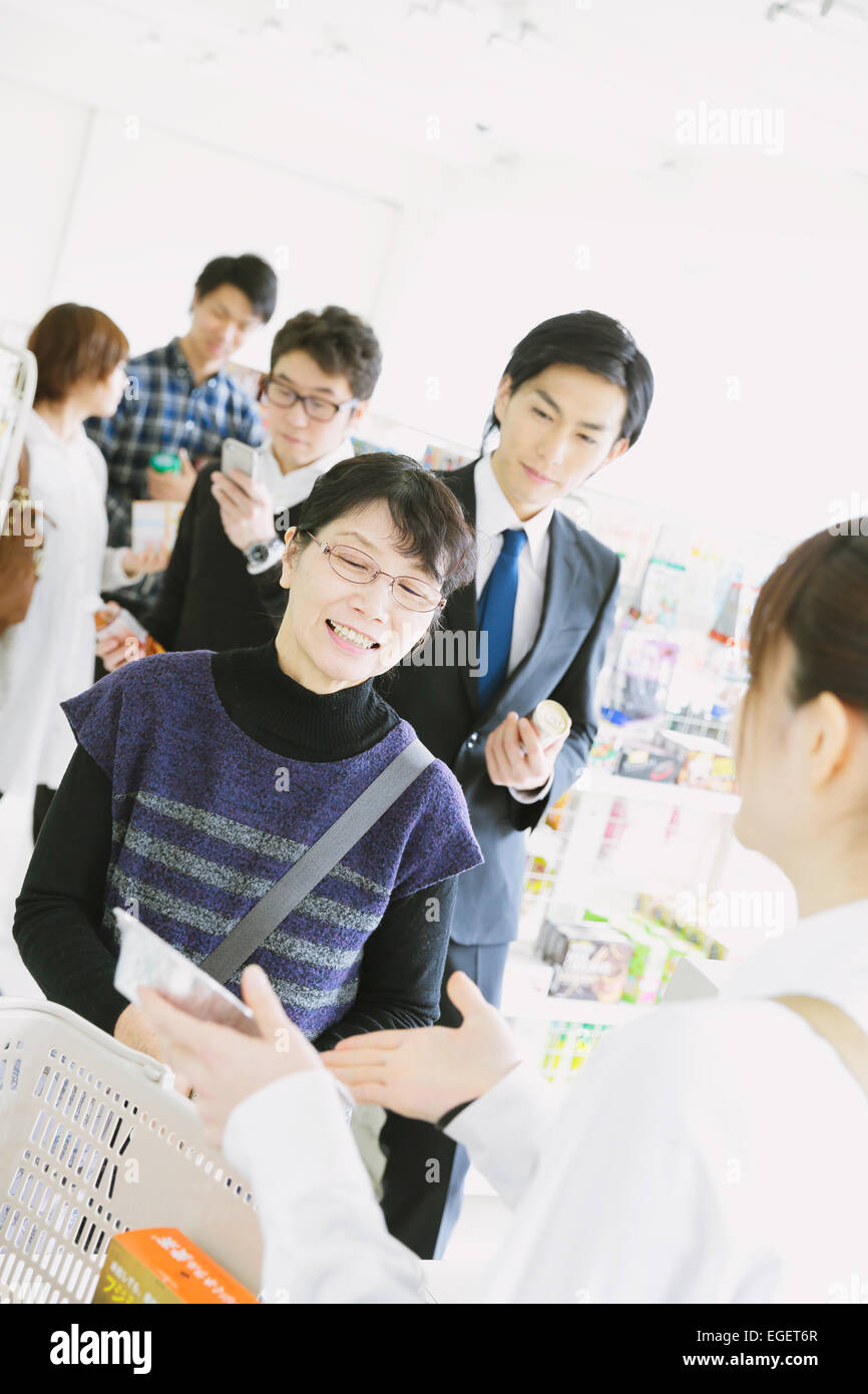 Customers shopping at a convenience store Stock Photo - Alamy