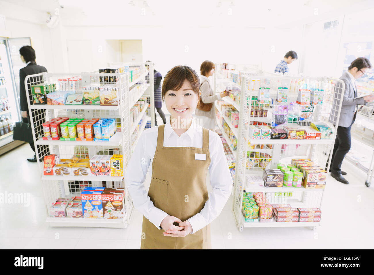 Young Japanese woman working at convenience store Stock Photo - Alamy
