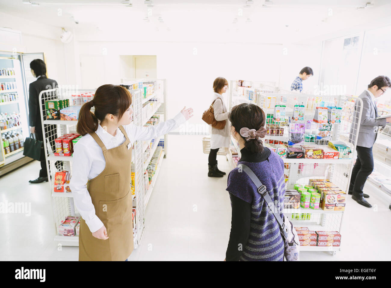 Young Japanese woman working at convenience store Stock Photo - Alamy