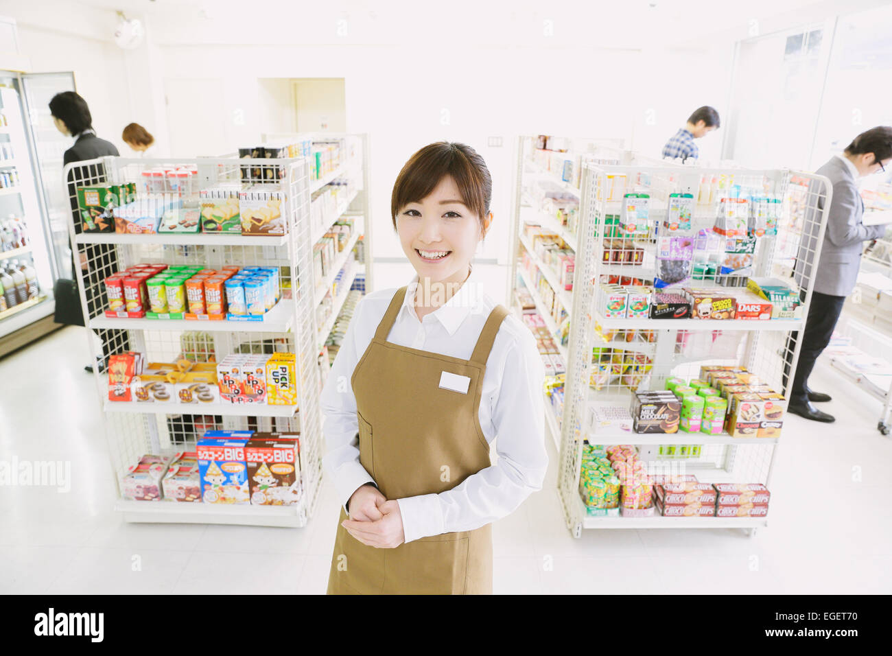Young Japanese woman working at convenience store Stock Photo - Alamy