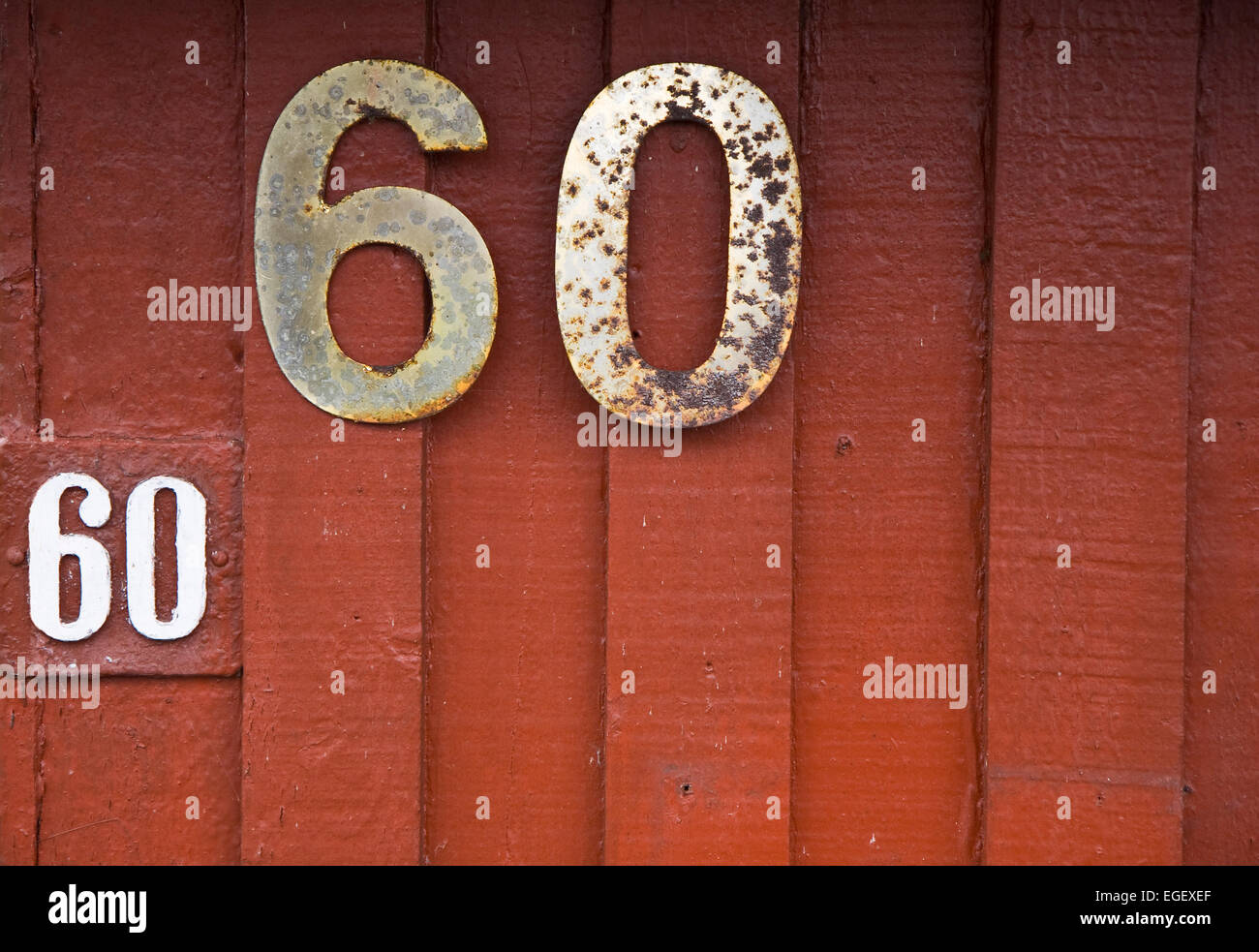 The number sixty on a red wall made of wood Stock Photo - Alamy