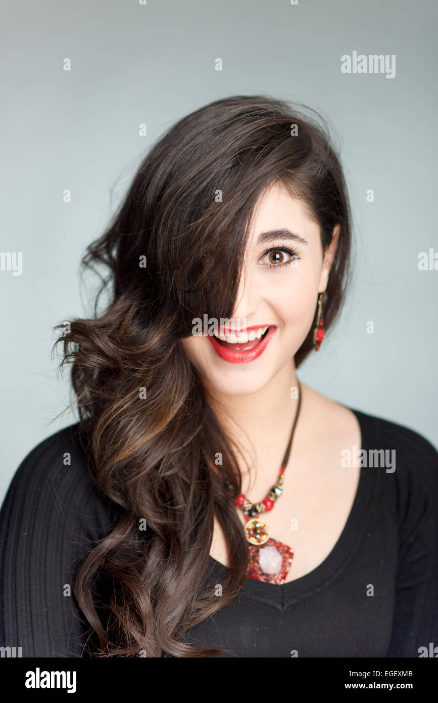 Surprised happy look hispanic girl on grey background Stock Photo - Alamy