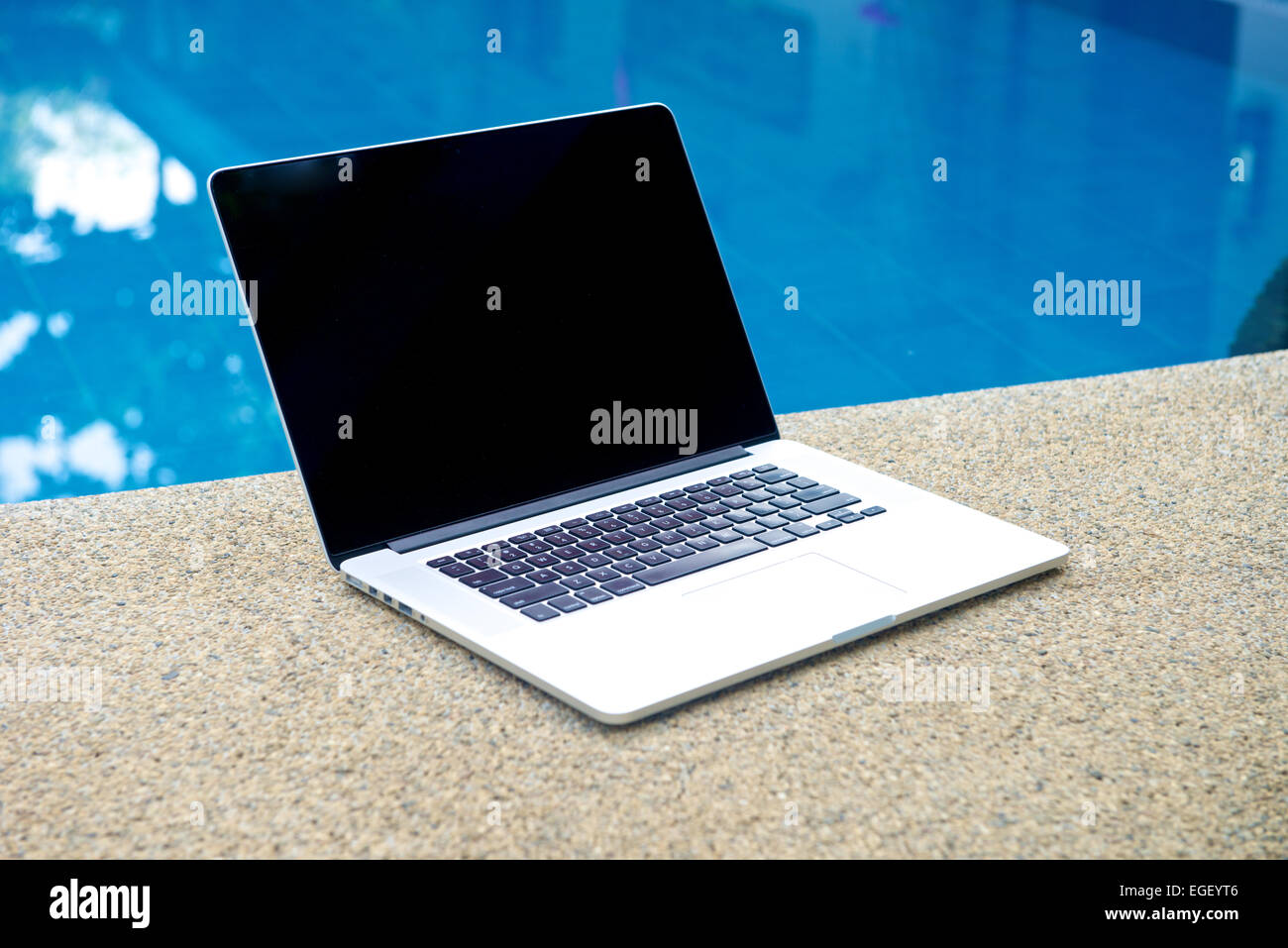 Laptop by the pool, working on vacation with mobility concept Stock ...