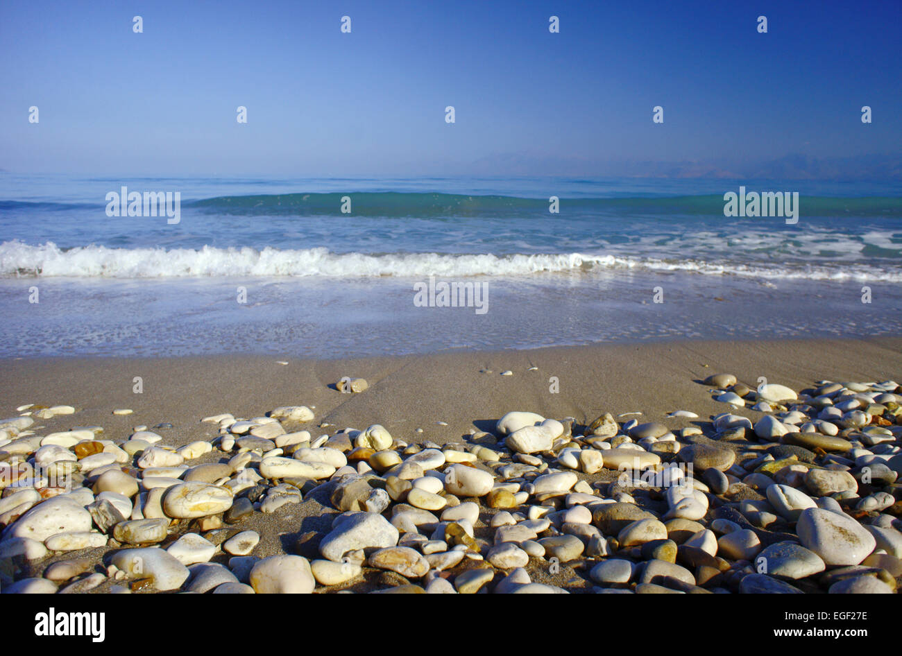Pebbles on a sandy beach on the island of Corfu Stock Photo - Alamy