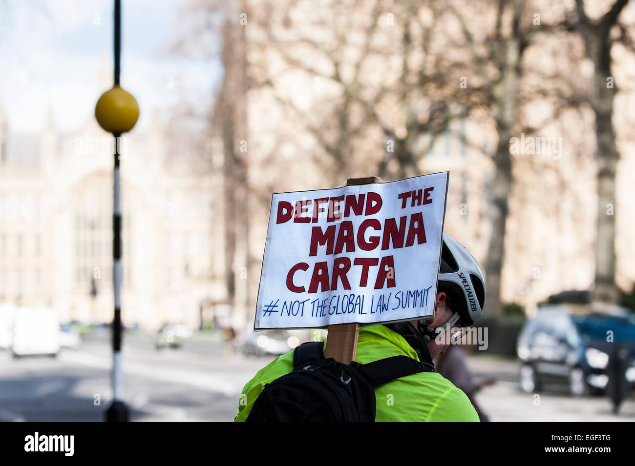 A cyclist with a placard joining a rally outside Parliament today in ...