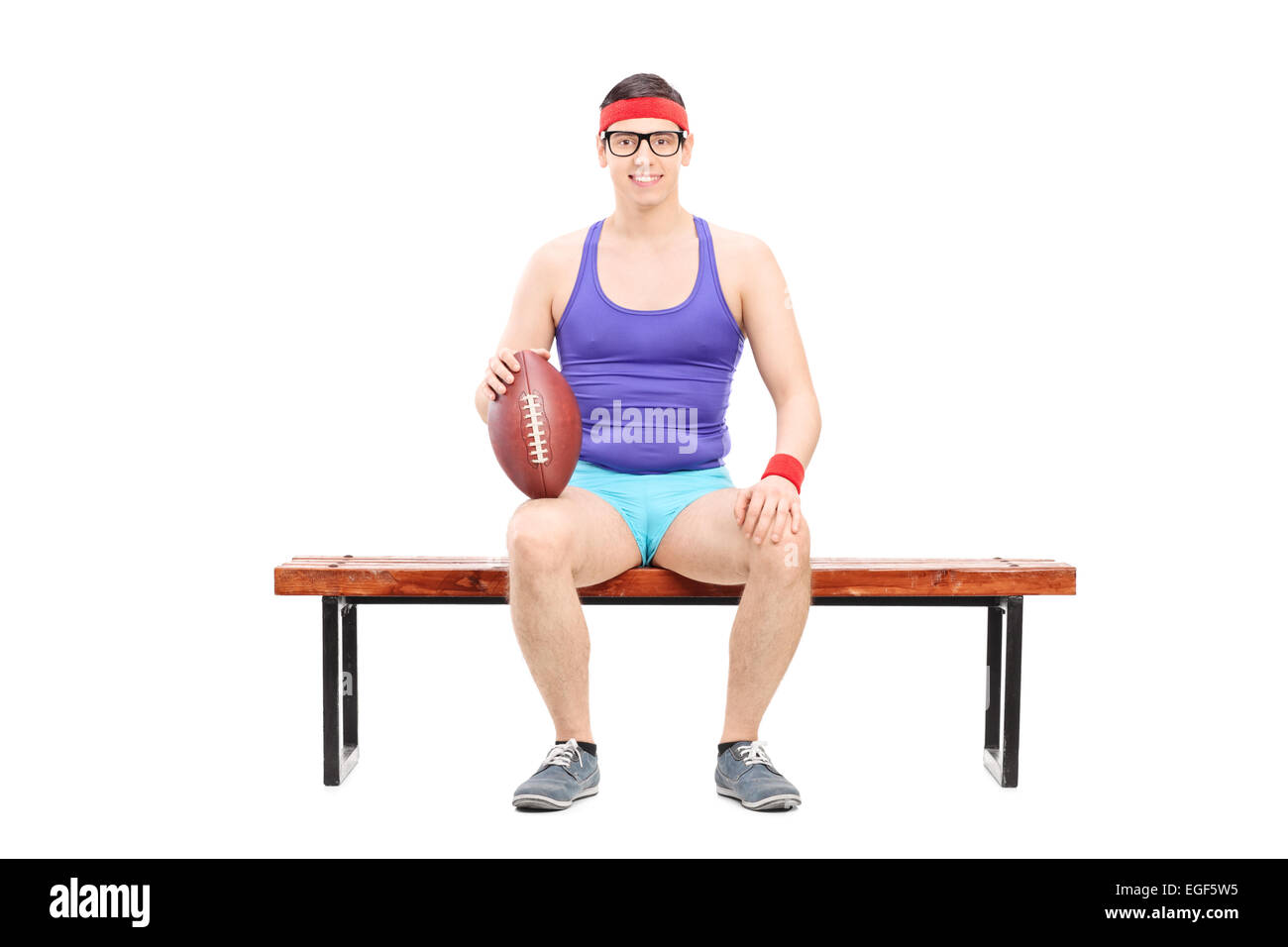 Male football player sitting on a bench isolated on white background ...