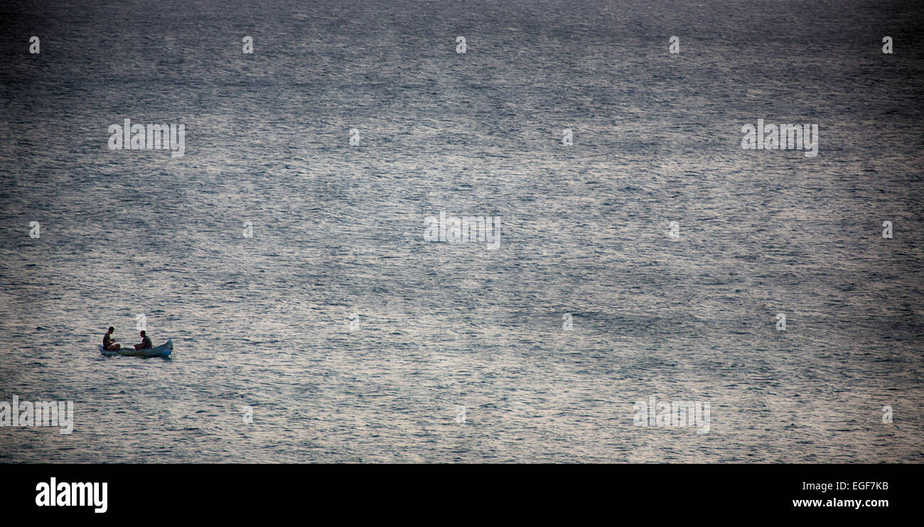 Fisherman work their lines in the open sea aboard a small boat Stock ...