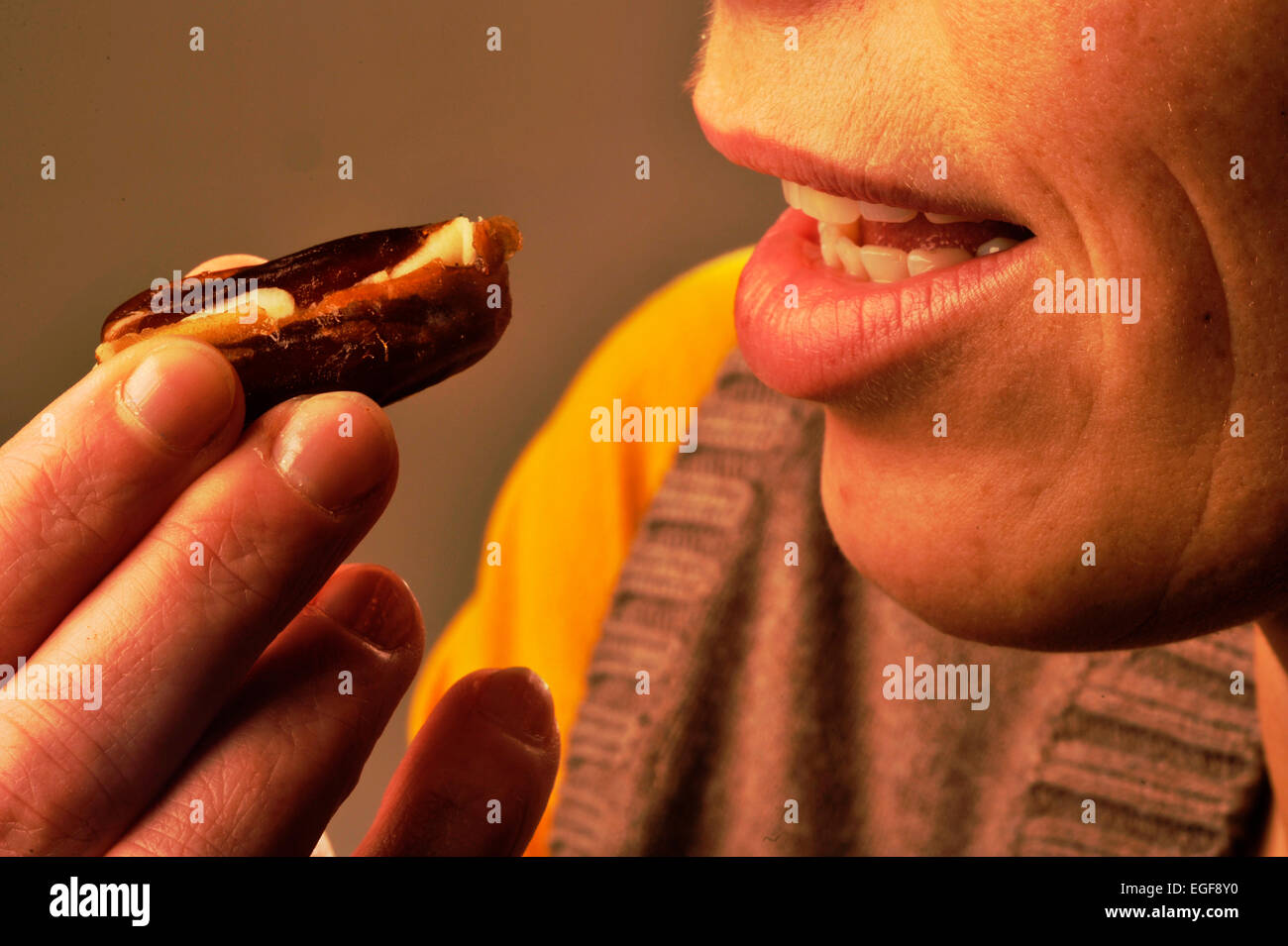 Symbolic picture about sugar in foods: Woman eating a date Stock Photo ...