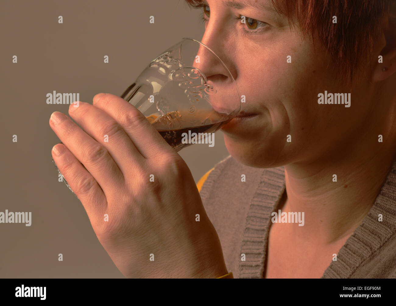Symbol photo about sugar in foods and beverages: Woman drinking Coca ...
