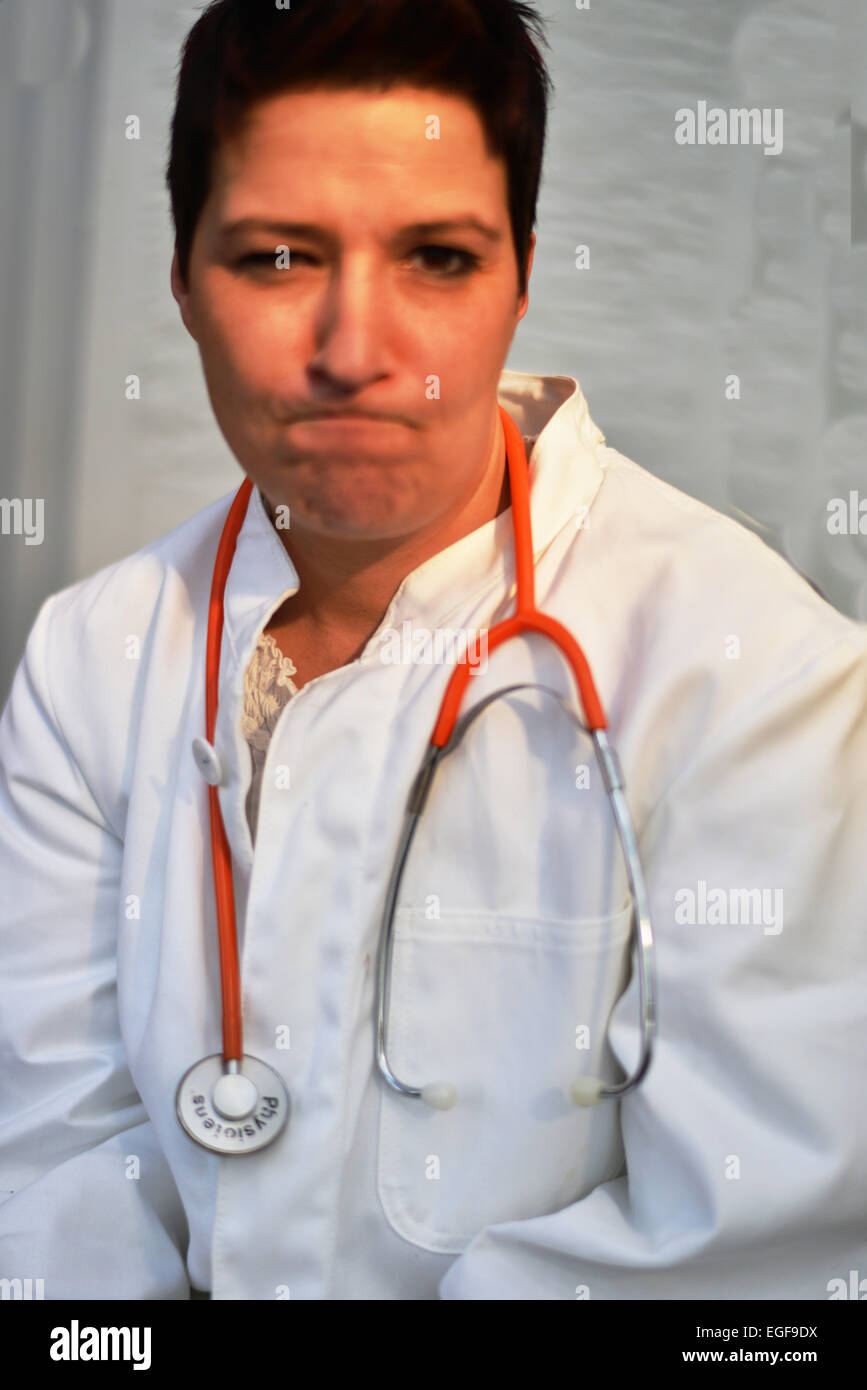 A doctor in a white coat and stethoscope with facial expressions. Taken ...