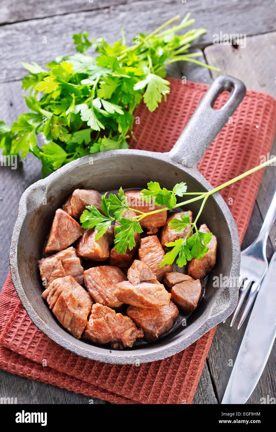 fried meat in pan and on a table Stock Photo - Alamy