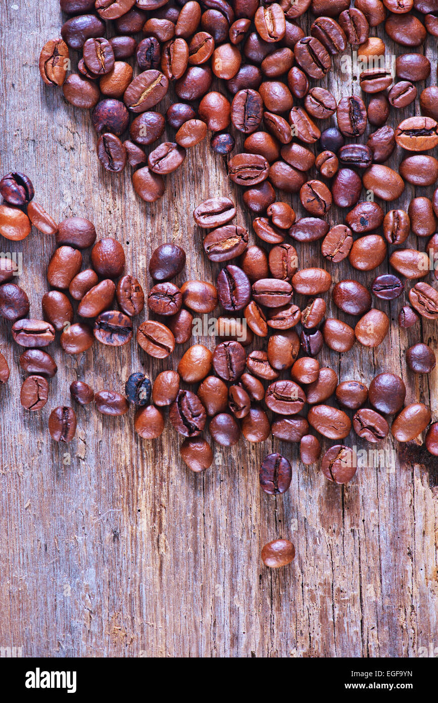 dry coffee beans on the wooden table Stock Photo - Alamy