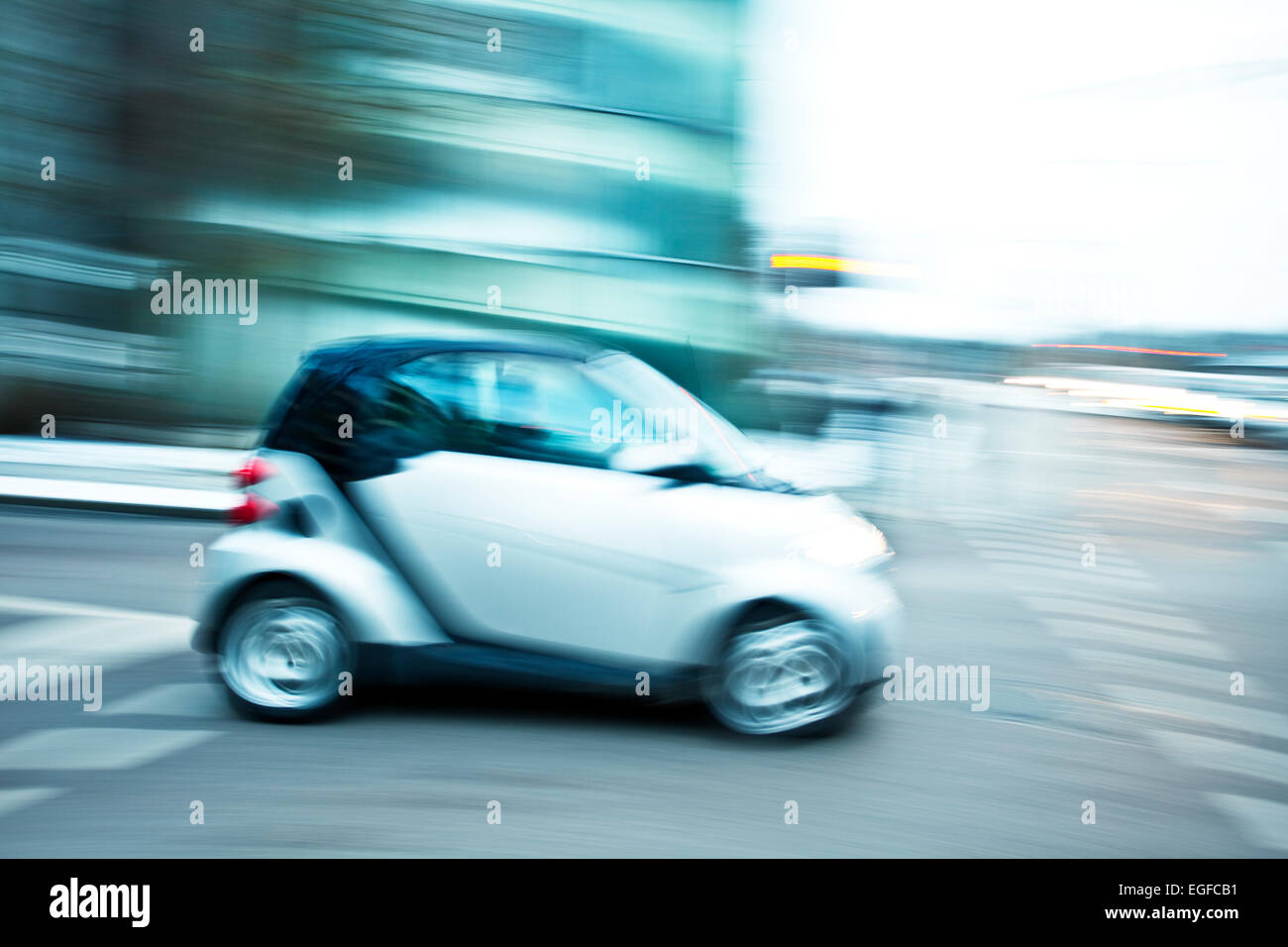 Cars driving fast in city Stock Photo - Alamy