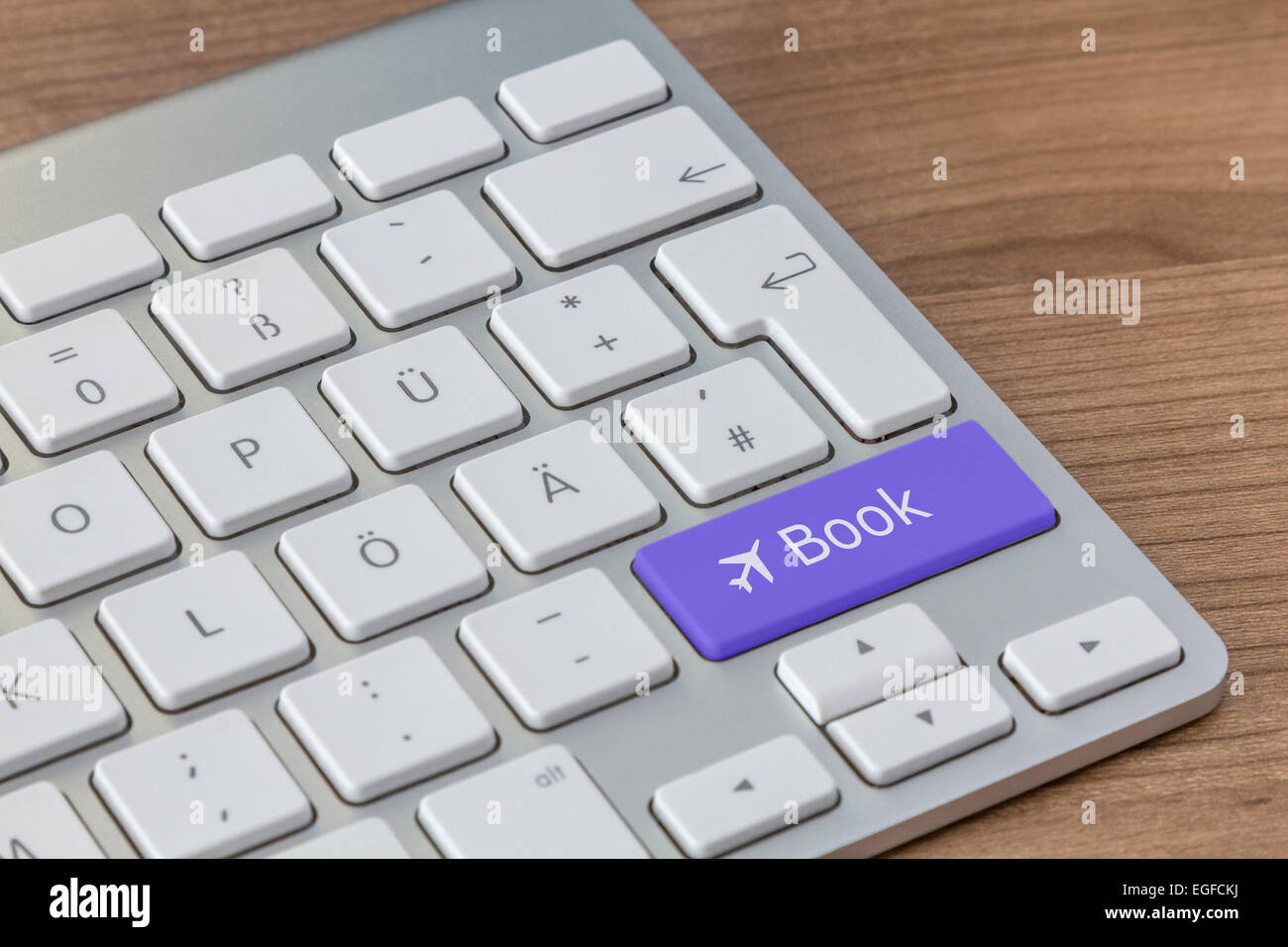 Book and aircraft symbol on a large blue button of a modern keyboard on ...