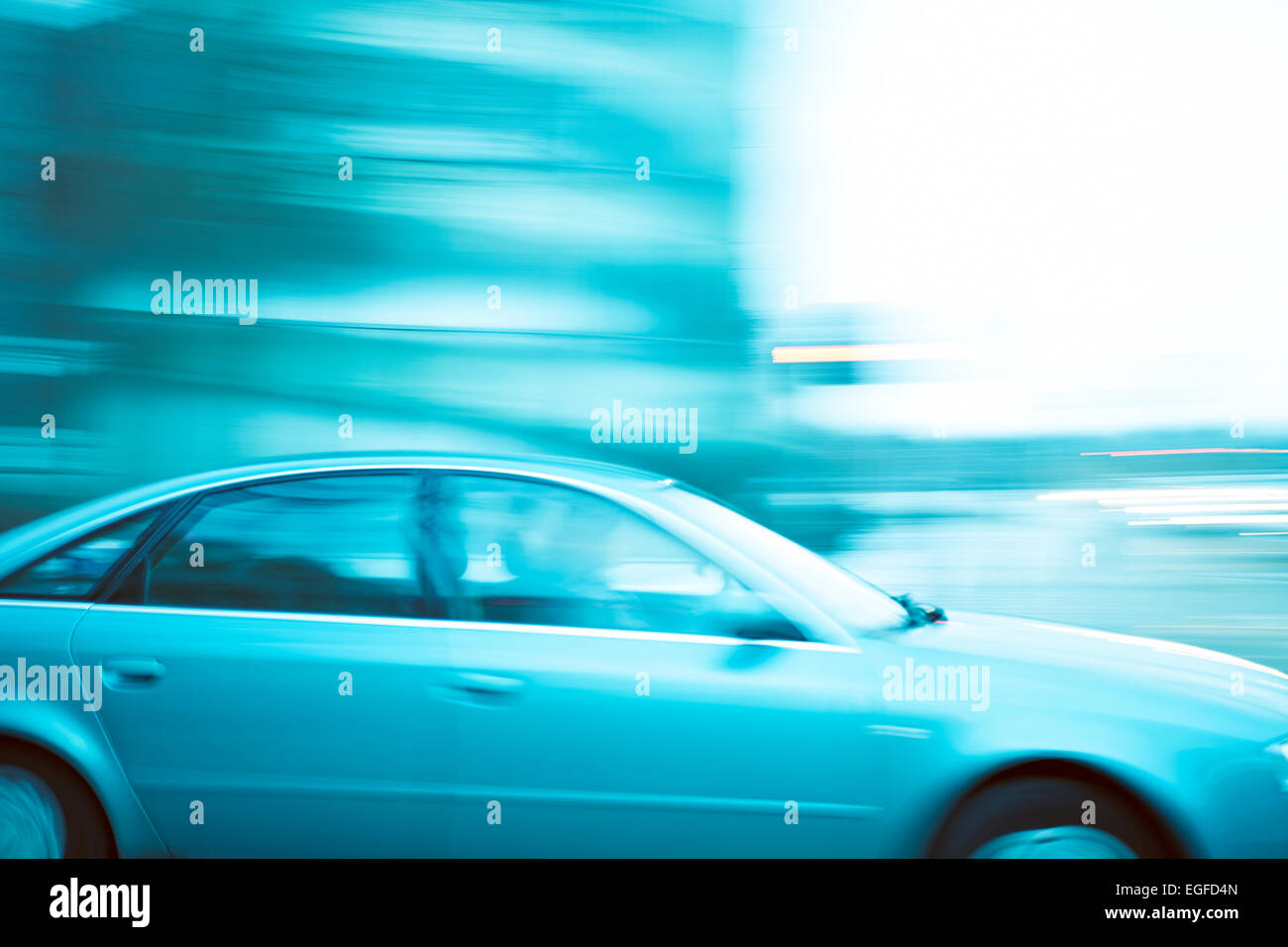 Cars driving fast in city Stock Photo - Alamy