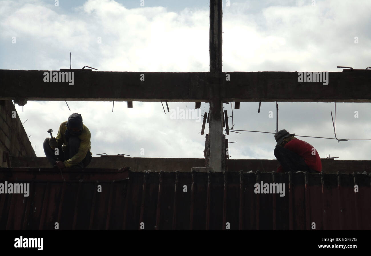 Filipino workers pound their hammers, as they demolish an abandoned ...