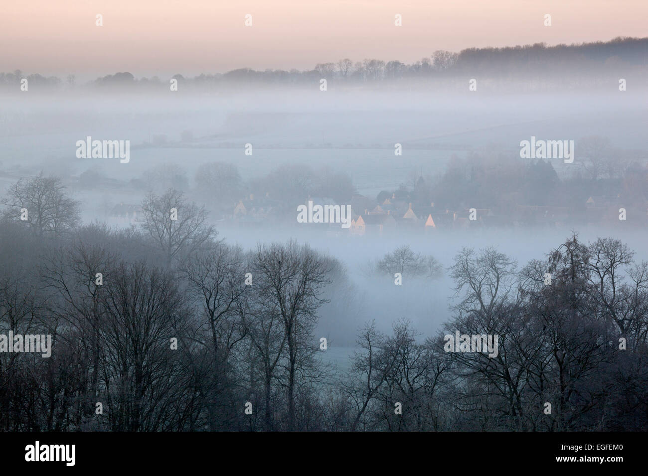 Winter view of Lower Swell village in dawn frost and fog, Stow-on-the ...