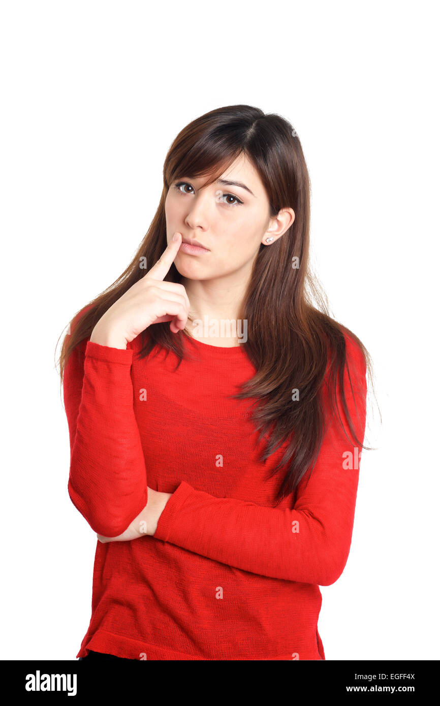 Girl in red with thinking hand gesture on white background Stock Photo ...