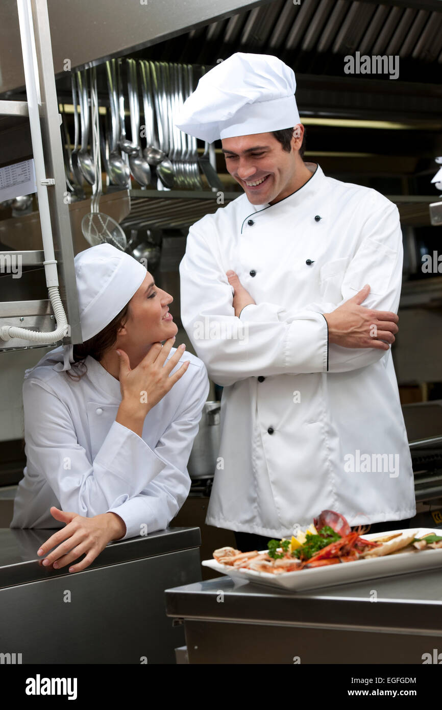 Two Cooks speaking in the kitchen Stock Photo - Alamy