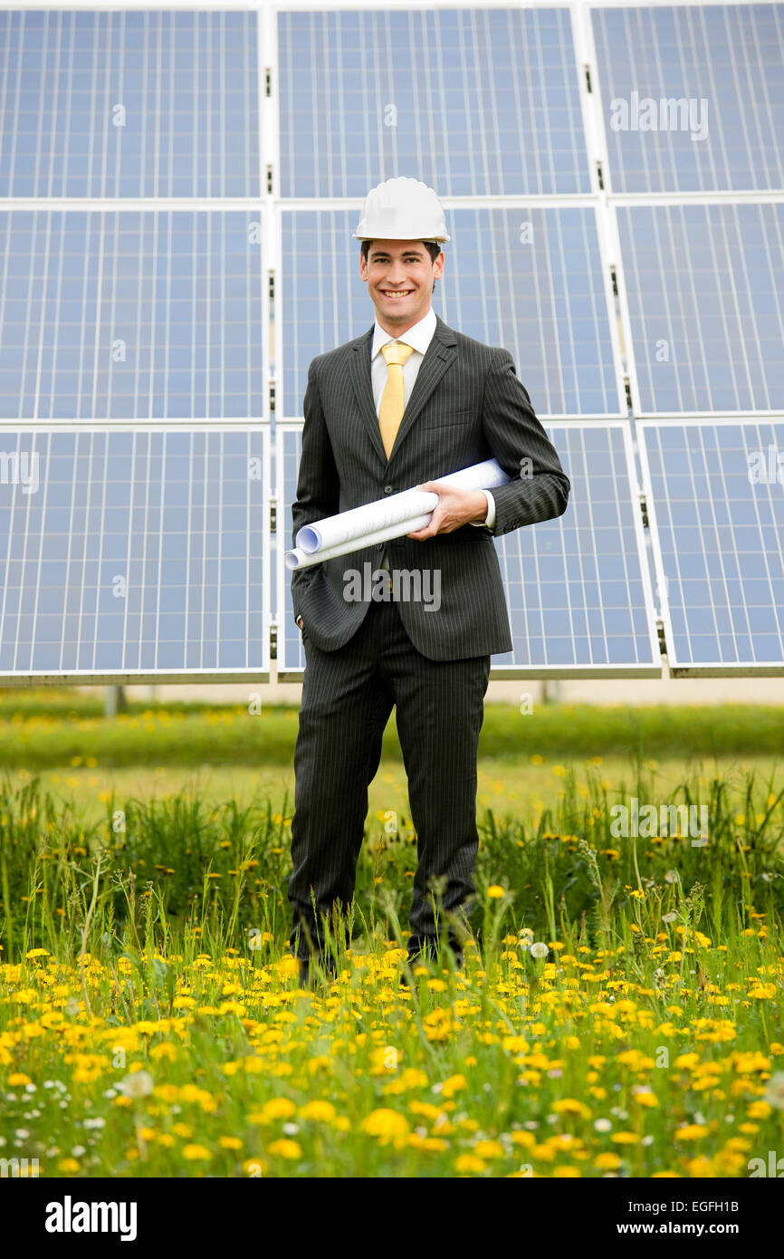 Male engineer at solar power station holding blueprints Stock Photo - Alamy