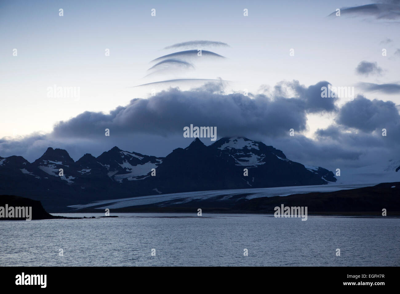 South Atlantic, South Georgia, layered clouds over mountains at dawn ...