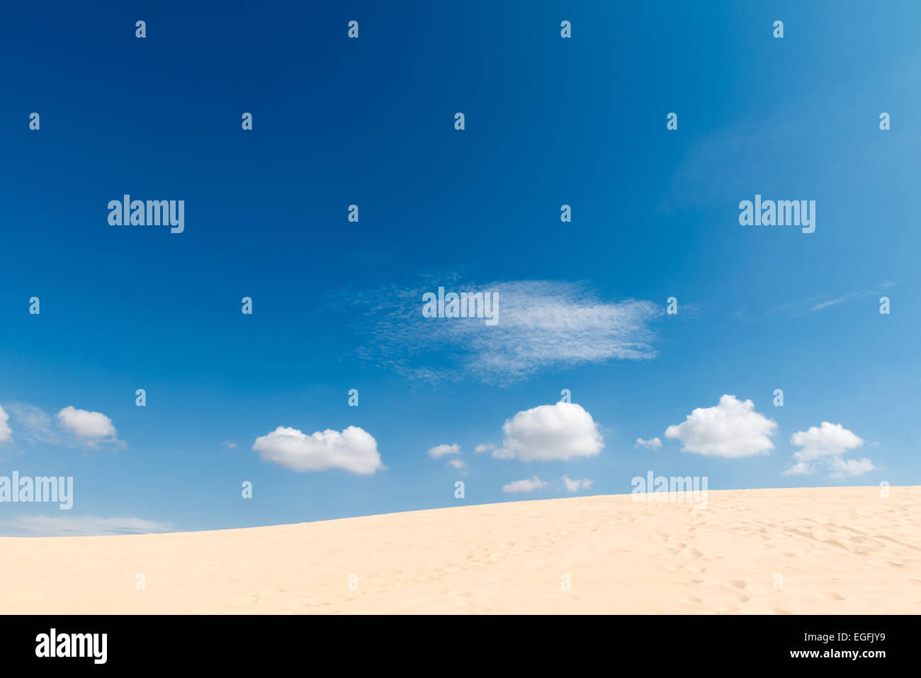 Desert sand dunes landscape with deep blue sky and clouds Stock Photo ...