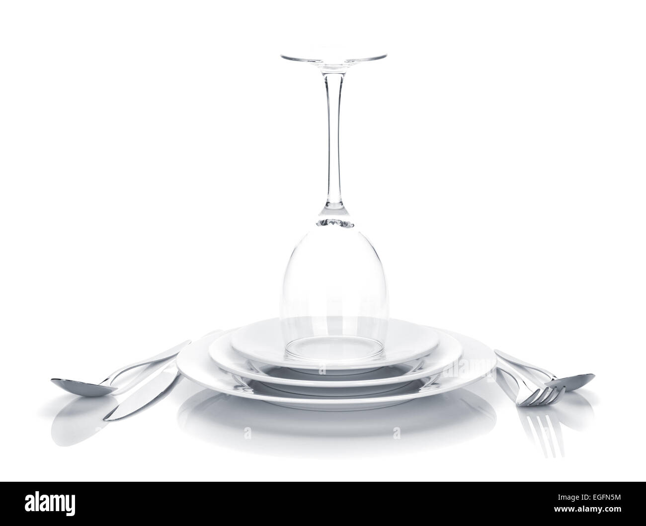 Silverware or flatware set and wine glass over plates. Isolated on ...