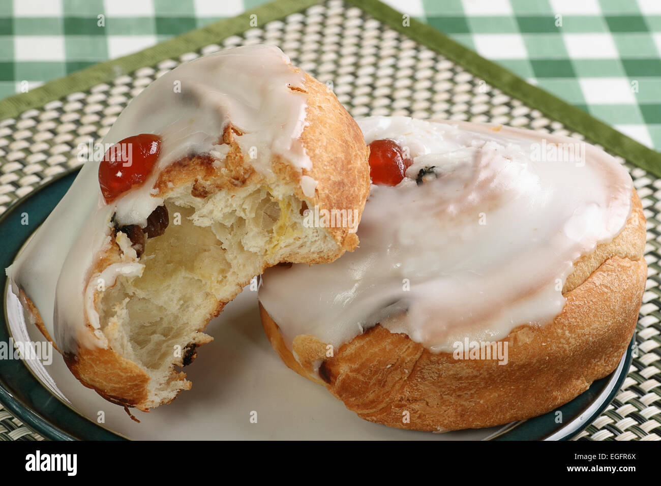 Two iced danish buns with cherry and raisins Stock Photo - Alamy