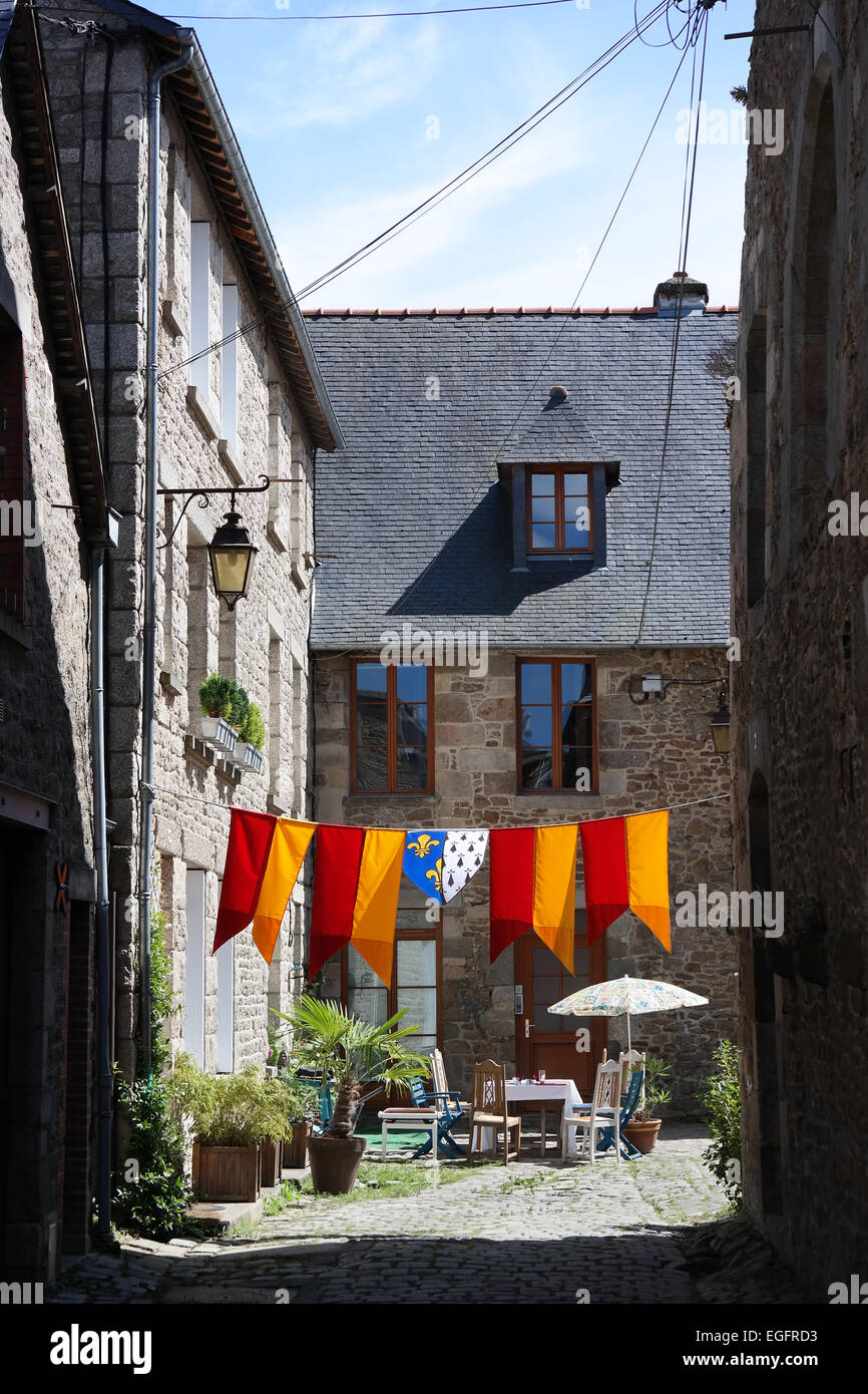 View at courtyard of medieval architecture with flags of coat of arms ...